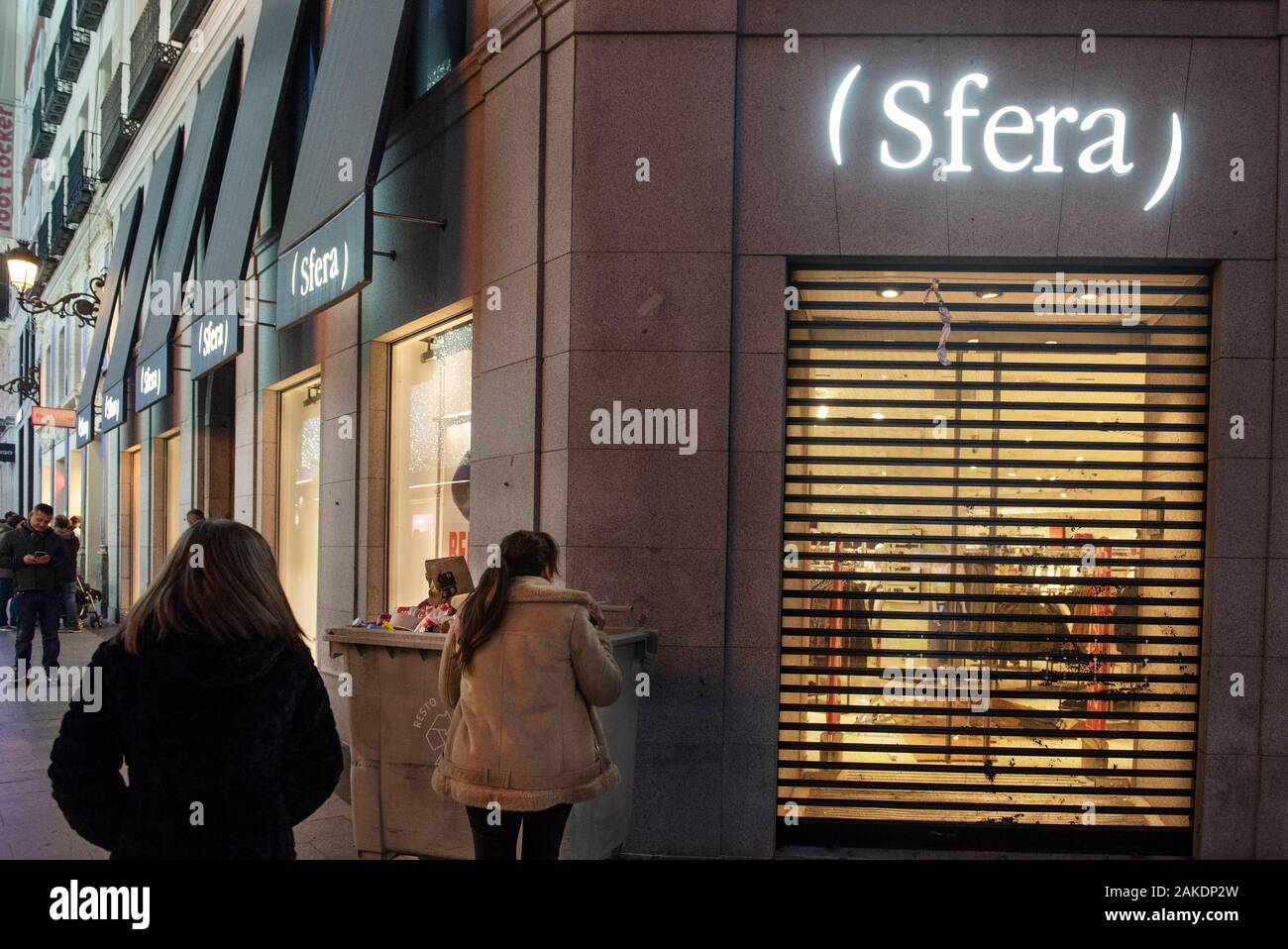 Pedestrians are seen walking past a Spanish clothing manufacturing and ...