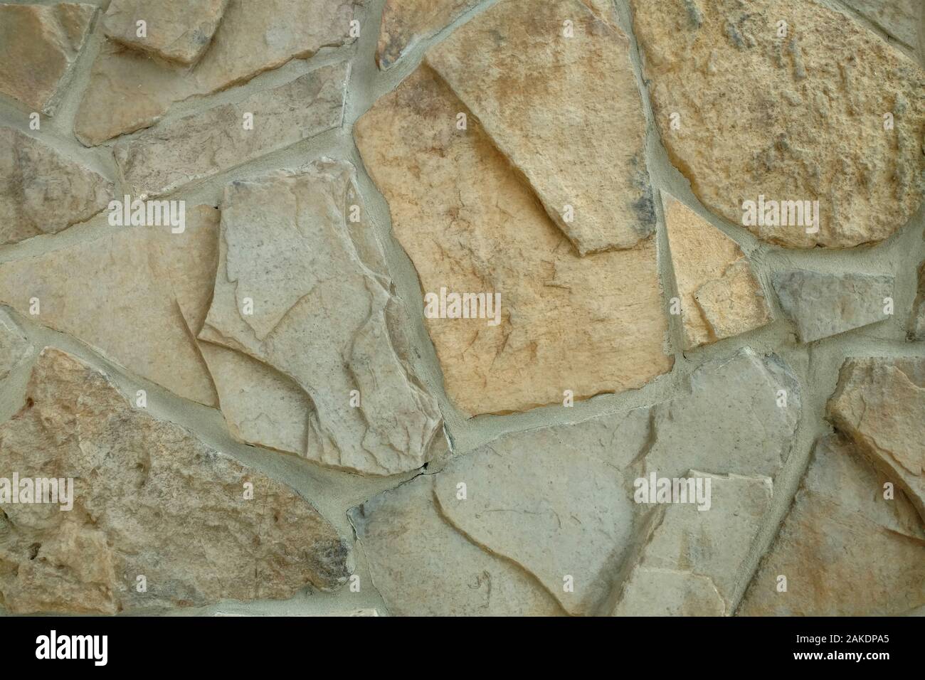 mixed stone rock wall thick sandy grout Stock Photo - Alamy
