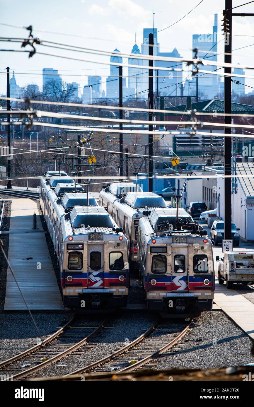 Image of two SEPTA trains parked on tracks in front of a the ...