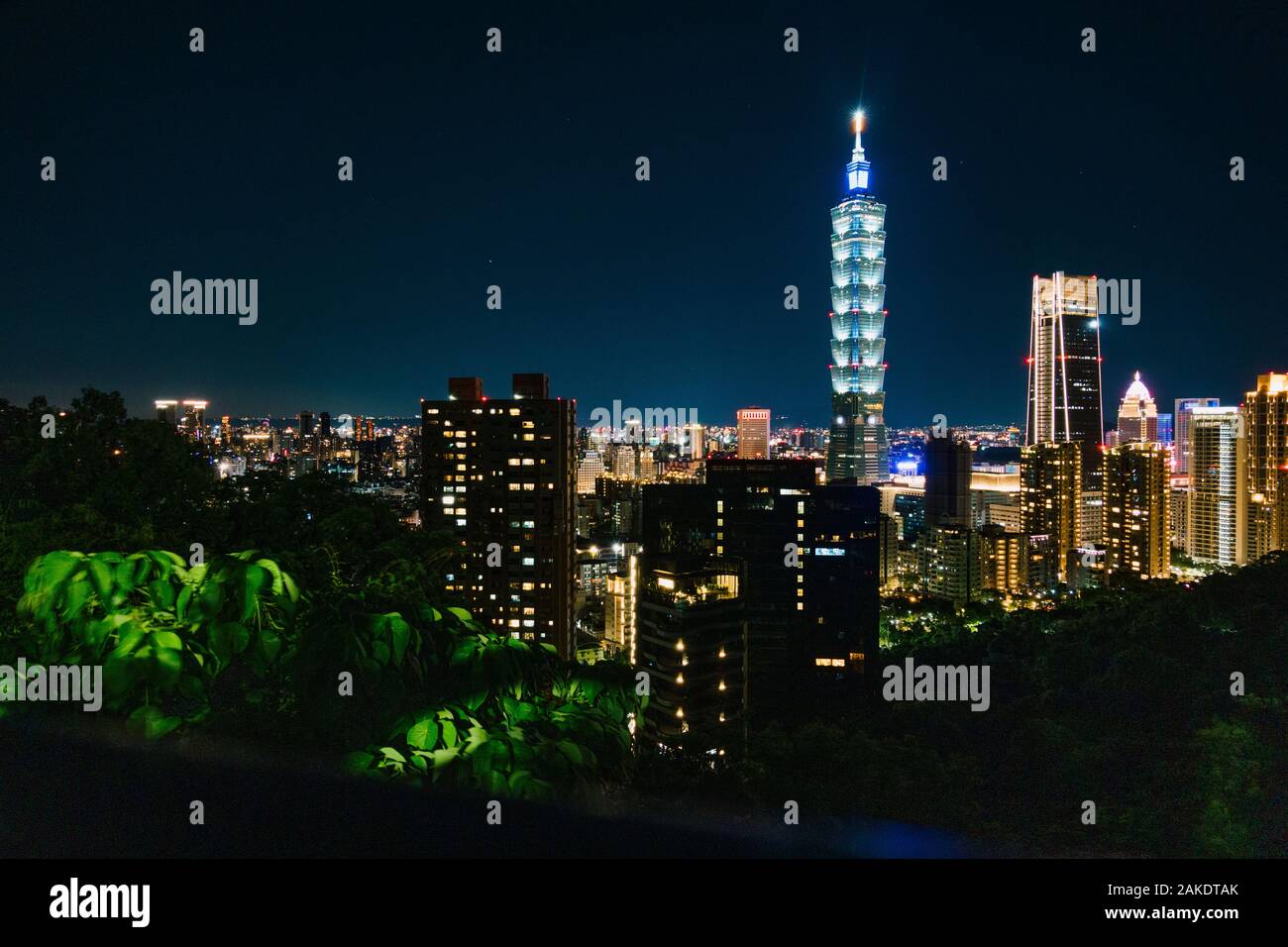 The Taipei 101 skyscraper and city skyline illuminated at night, as ...