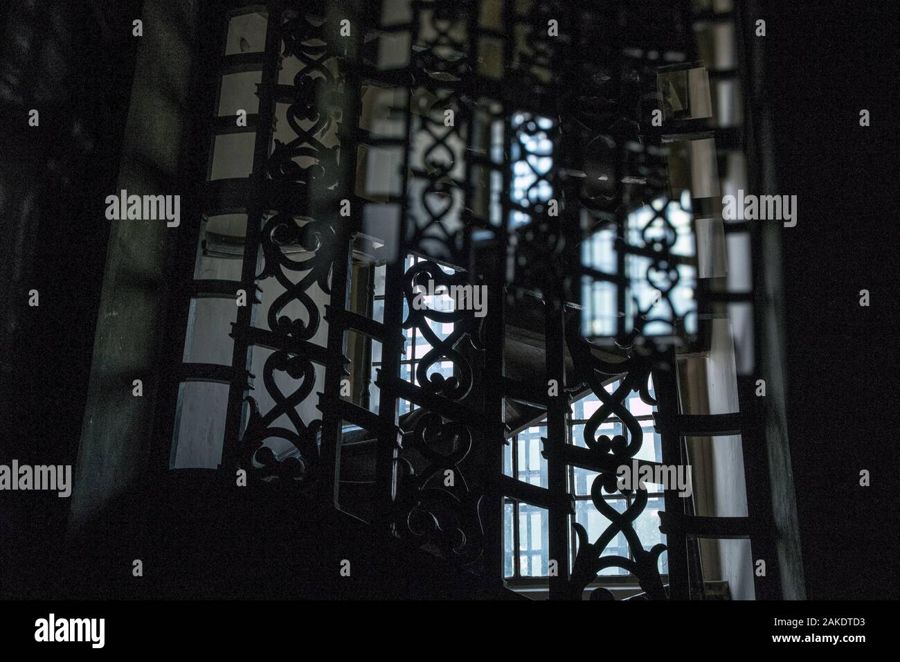 Dark metal window grate, ornate design, moody shadows Stock Photo - Alamy