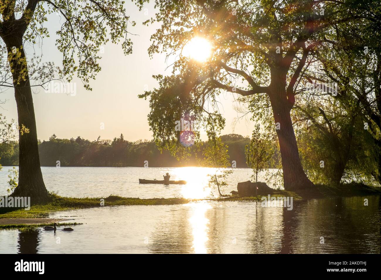 A man in a kayak fishing on Lake Nokomis in Minneapolis, Minnesota, USA ...