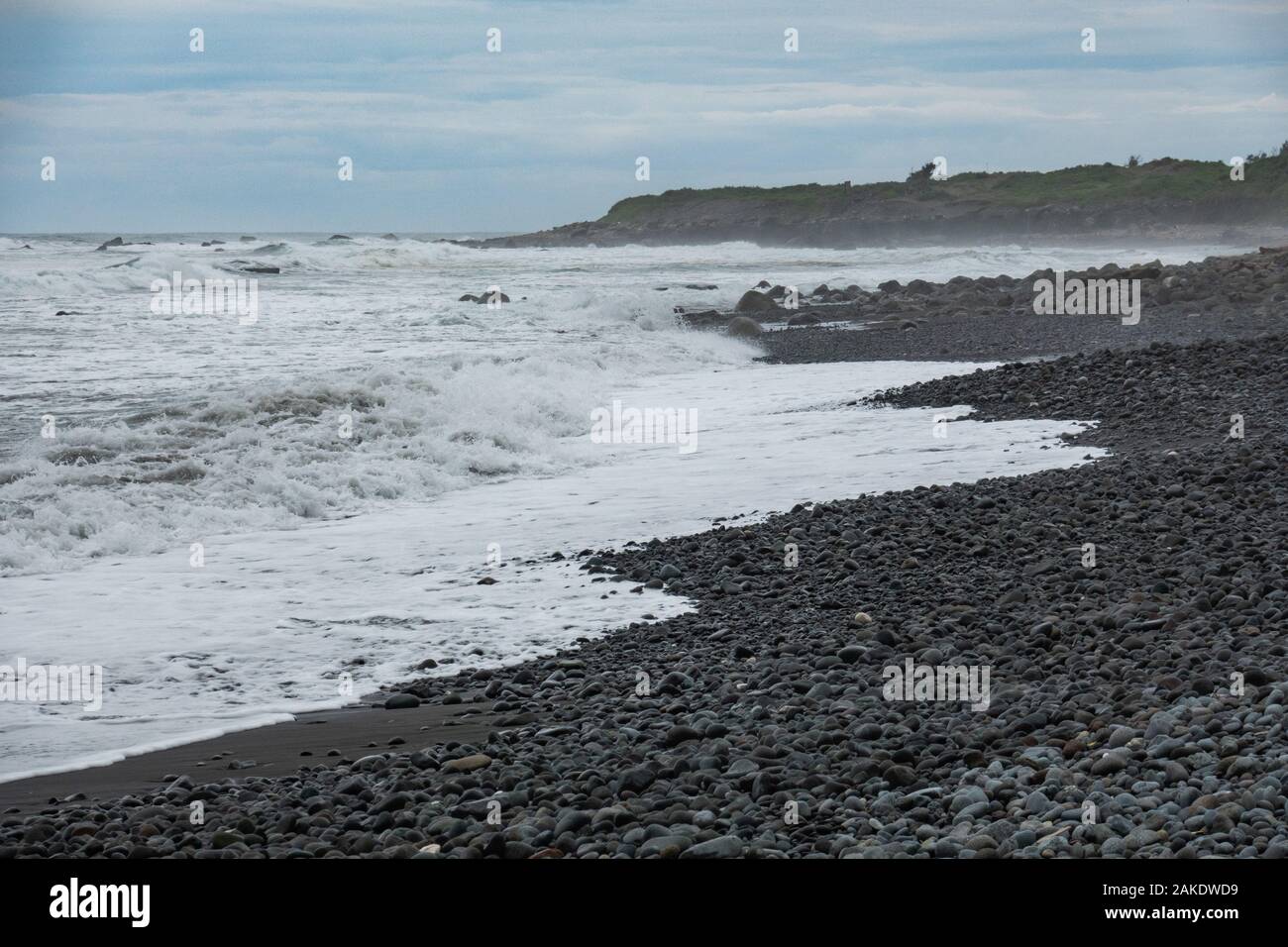 Strong waves break on the rocky shore of Dulan Beach, in southern ...