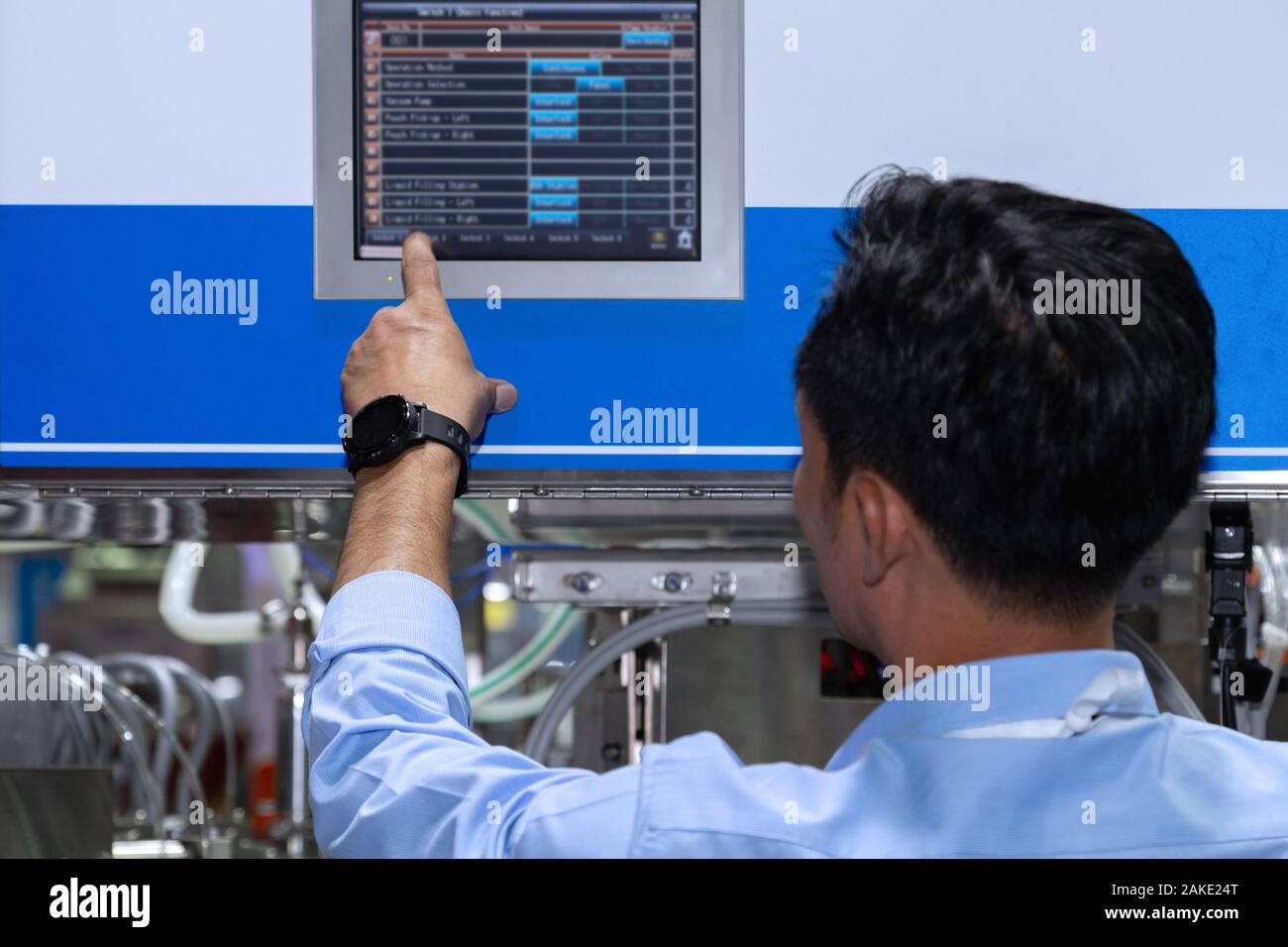 factory engineer controlling and pressing important technology button ...