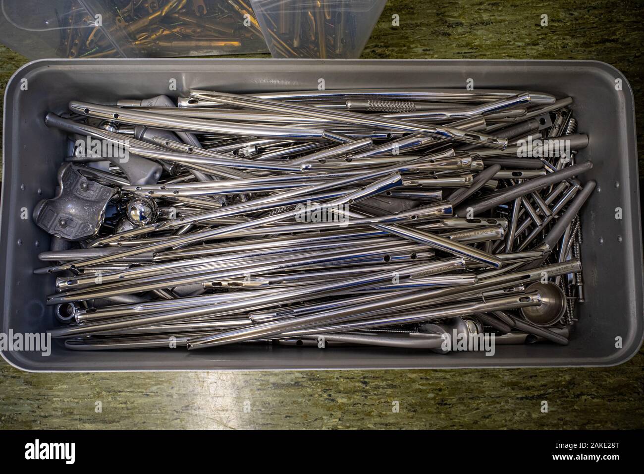 in a large steel box are many different surgical implants made of steel ...