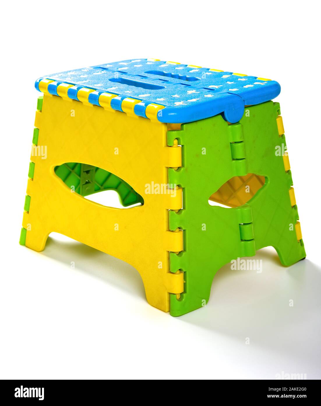 a small foldable plastic chair on white background Stock Photo - Alamy