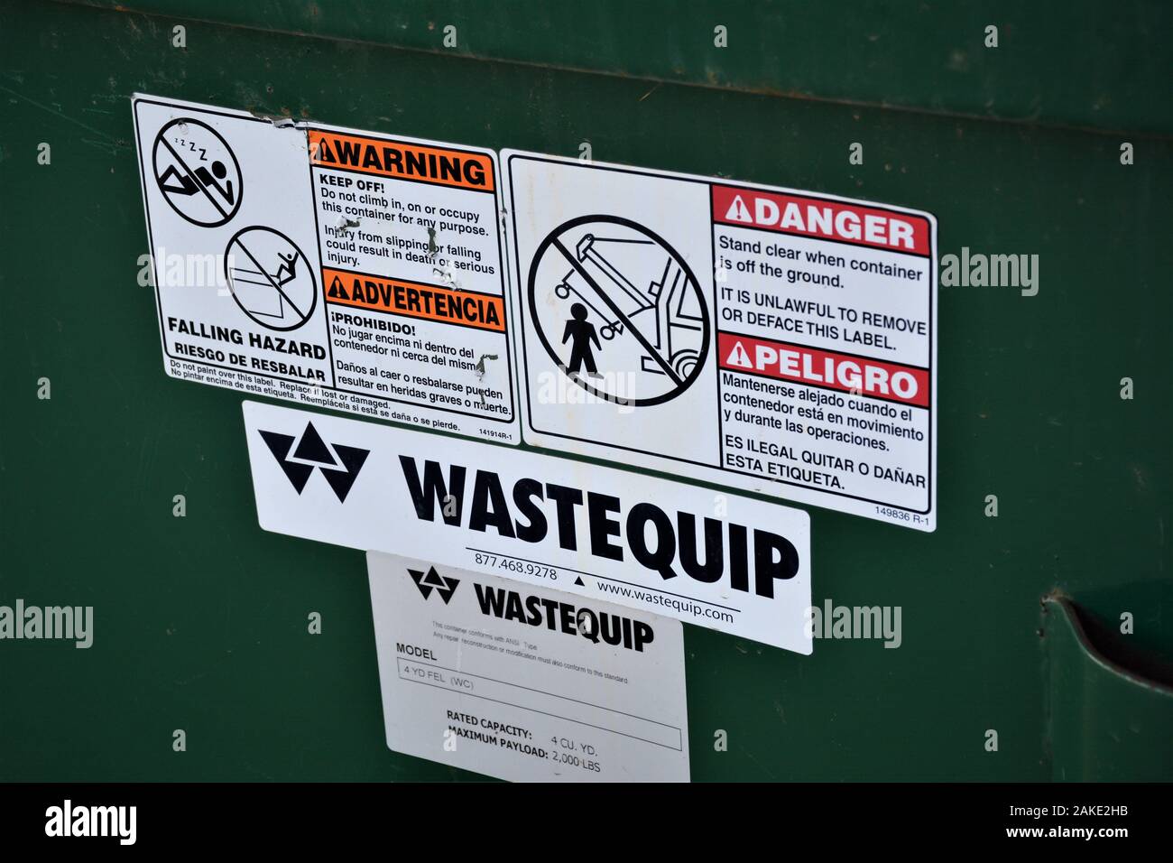 Danger sign on the side of a waste pick up site container as a warning ...