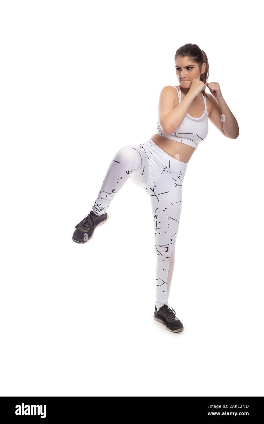 Woman showing core strength by balancing while kicking. She is training ...