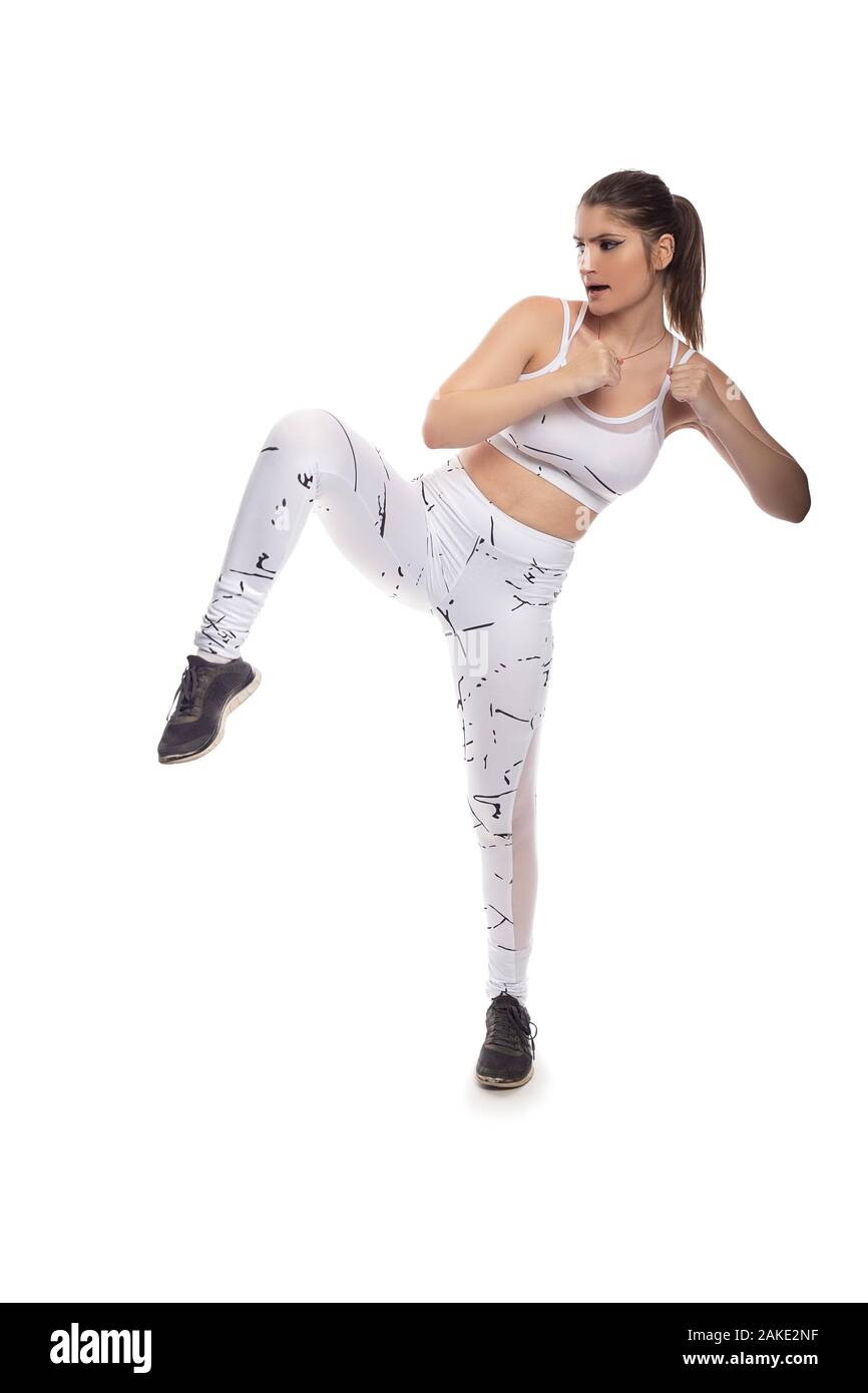 Woman showing core strength by balancing while kicking. She is training ...