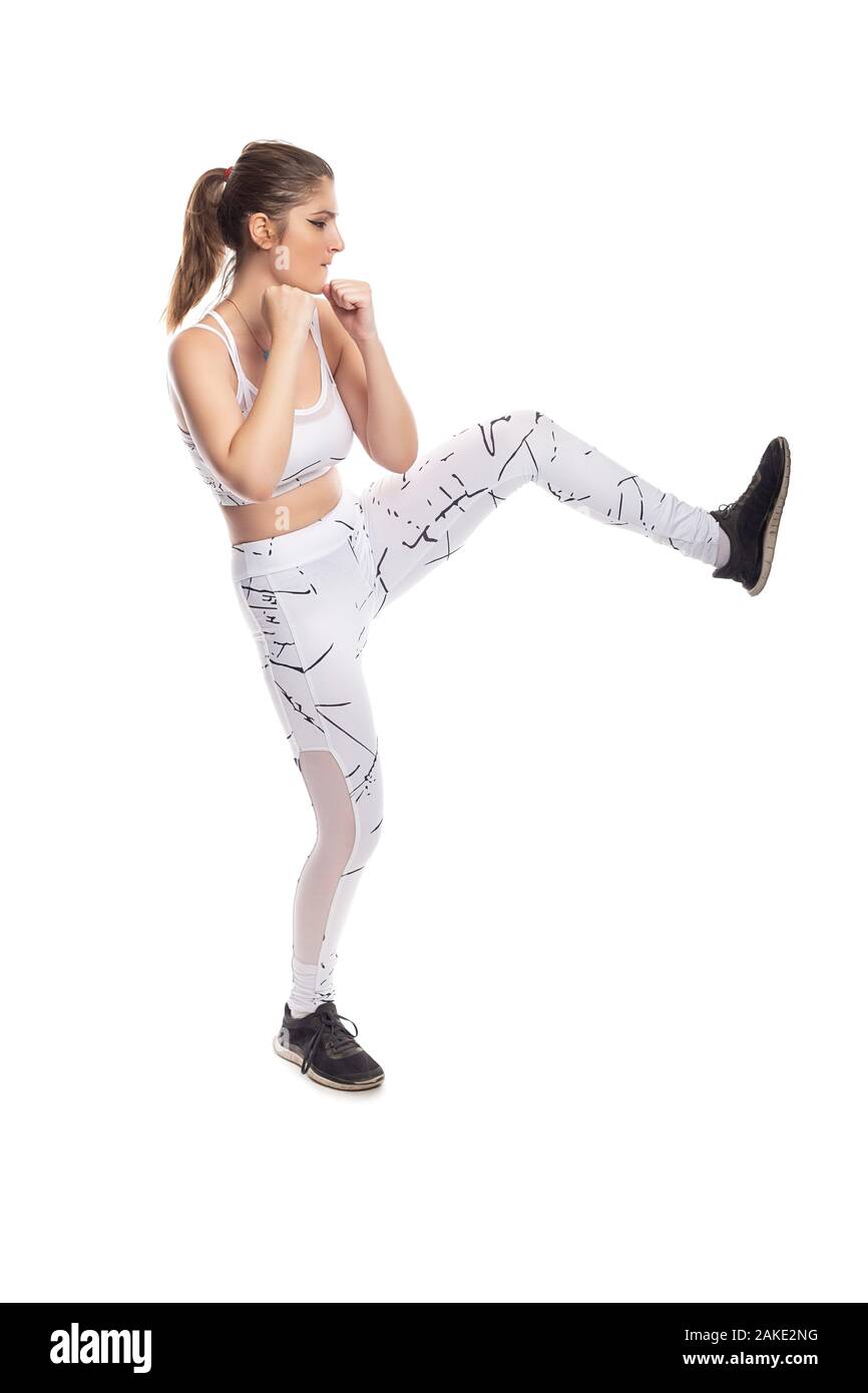 Woman showing core strength by balancing while kicking. She is training ...