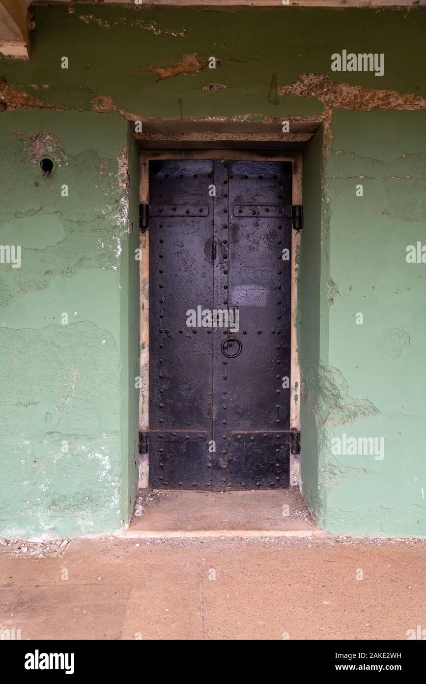 Large reinforced steel door blocking entrance of a old prison complex ...