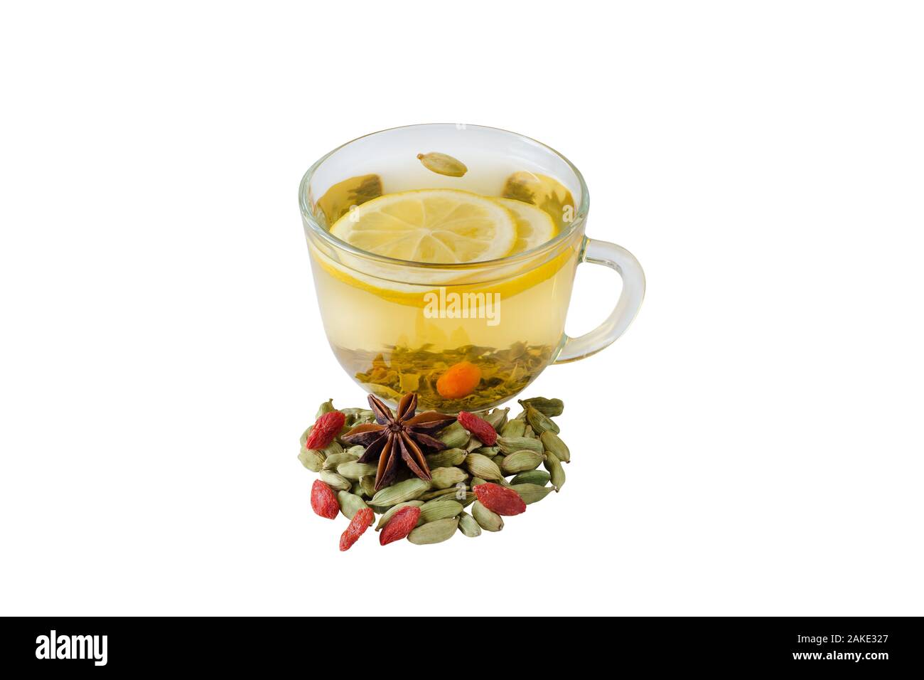 A glass of tea with lemon, goji, cardamom and cloves isolated on white ...