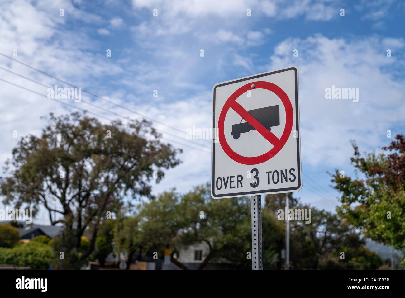 Street sign warning limiting vehicles over 3 tons with truck crossed ...
