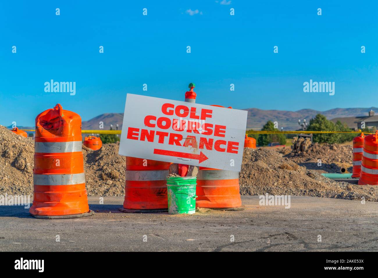 Road under construction with golf course entrance sign and traffic ...