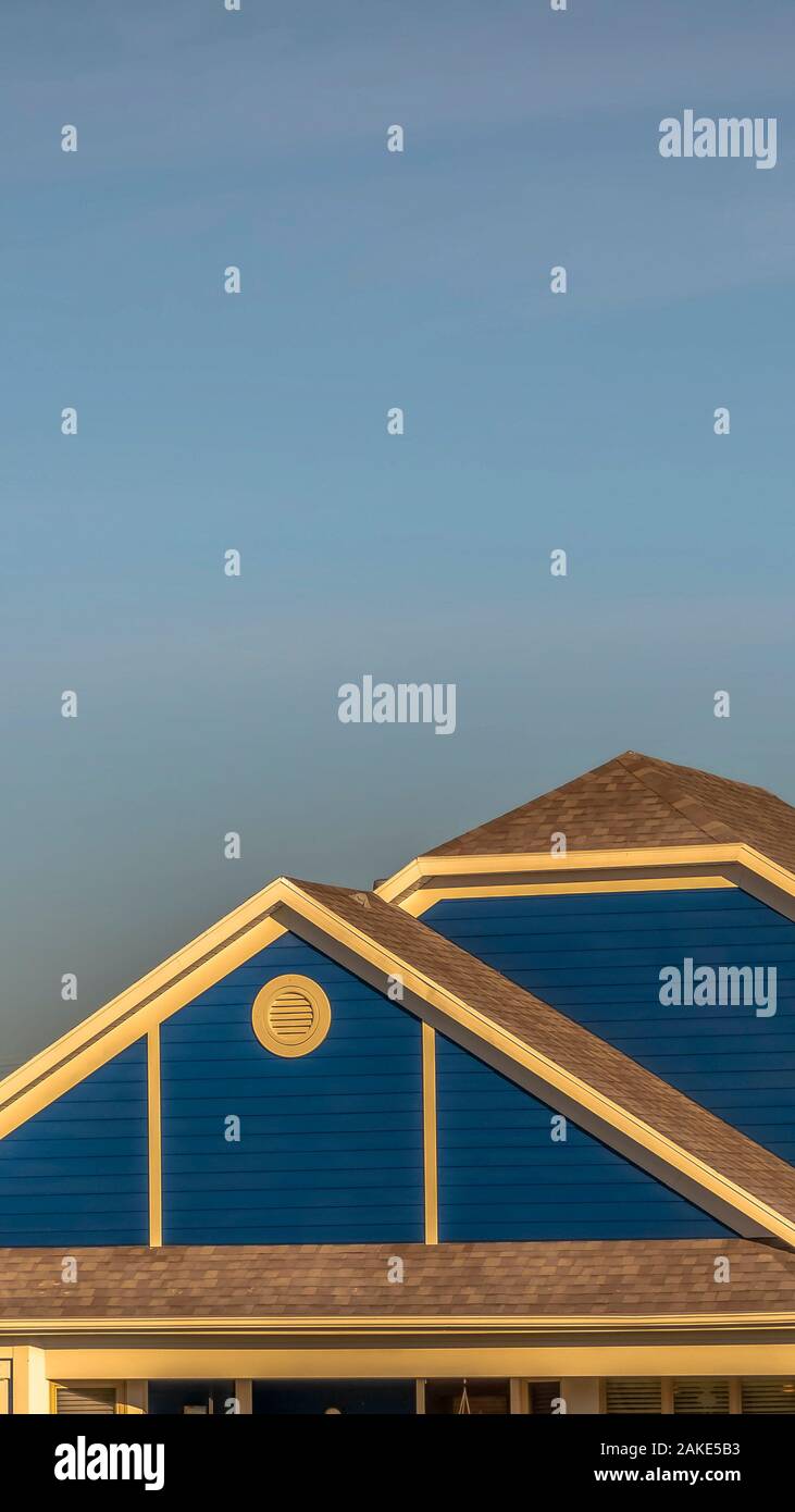 Vertical frame Close up of roof structure of home with blue gable wall ...
