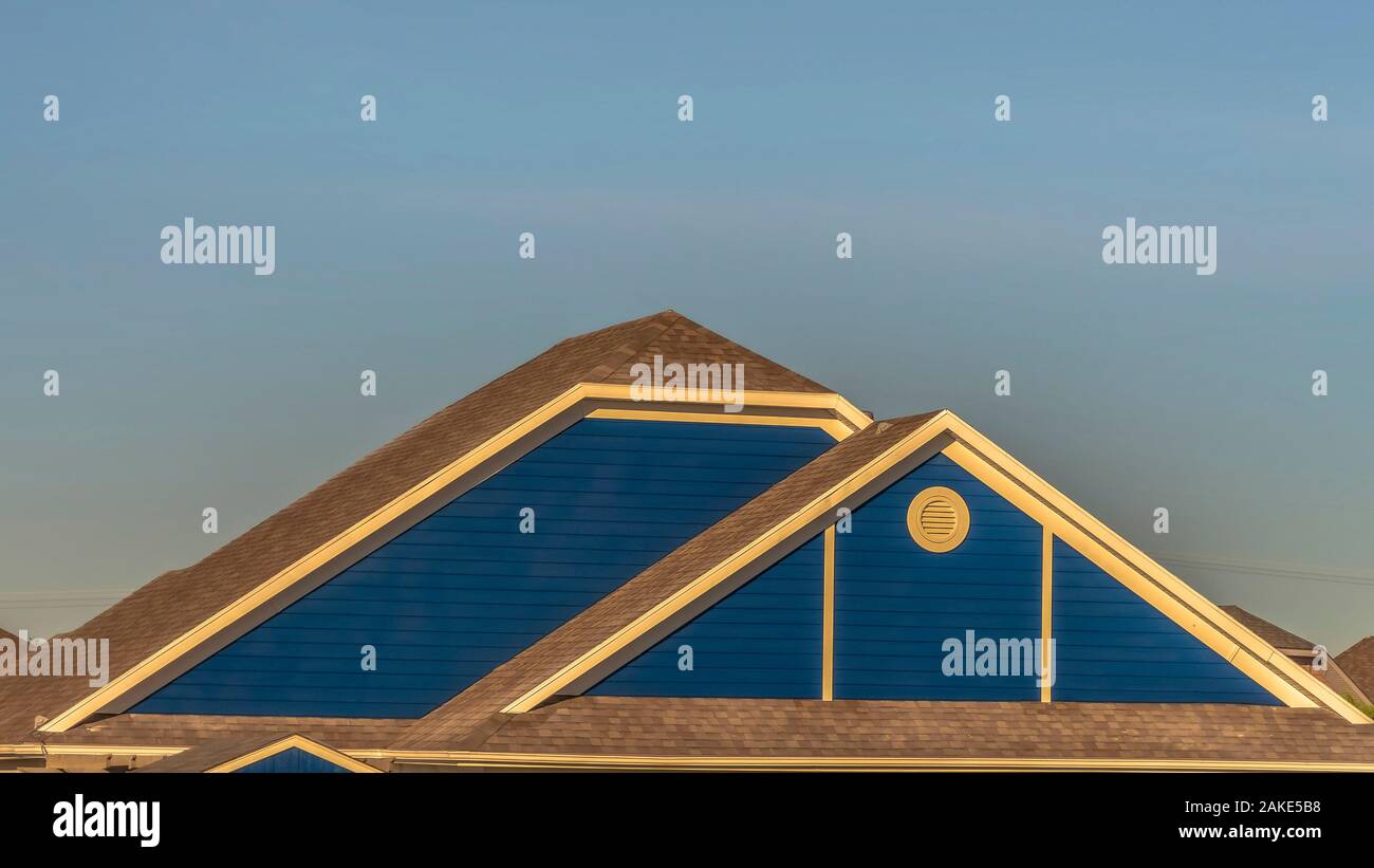 Panorama Close up of roof structure of home with blue gable wall and ...