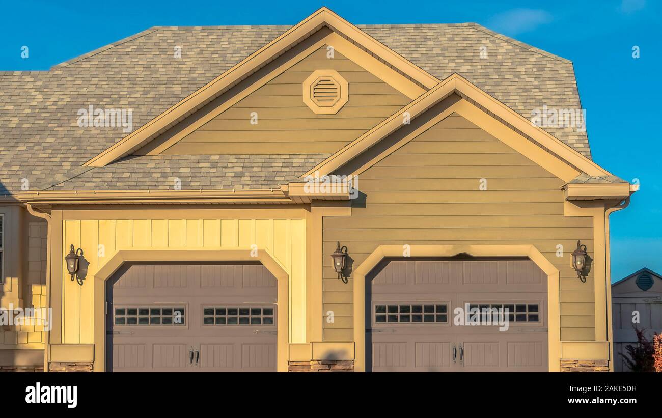 Panorama Facade of house with view of the gray two car garage against ...
