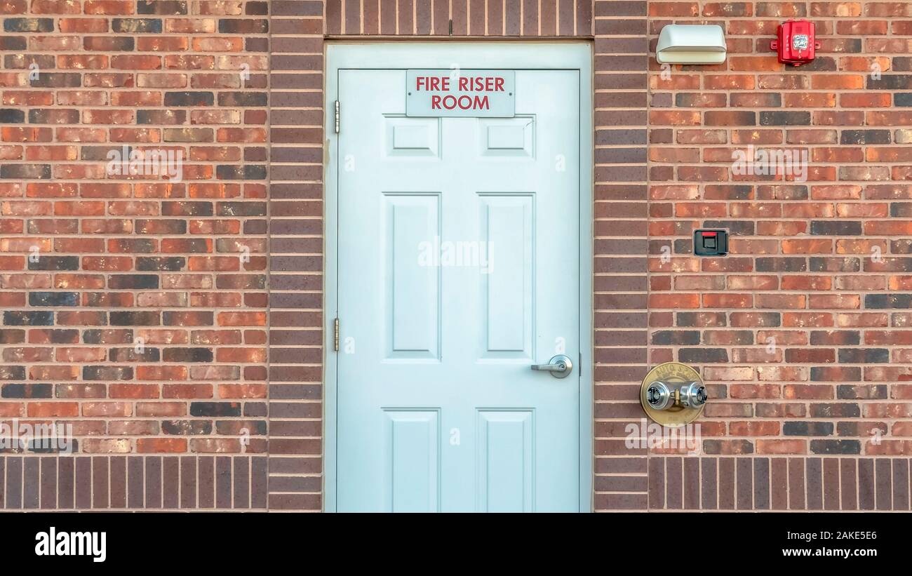 Panorama Fire Riser Room sign on the white wood door of a building with ...