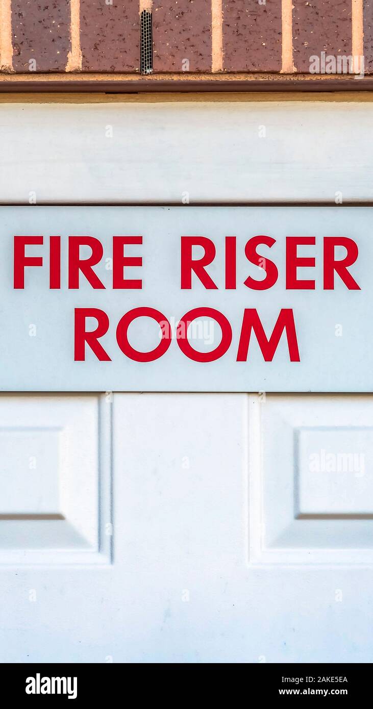 Vertical frame Close up of the Fire Riser Room with white wooden door ...