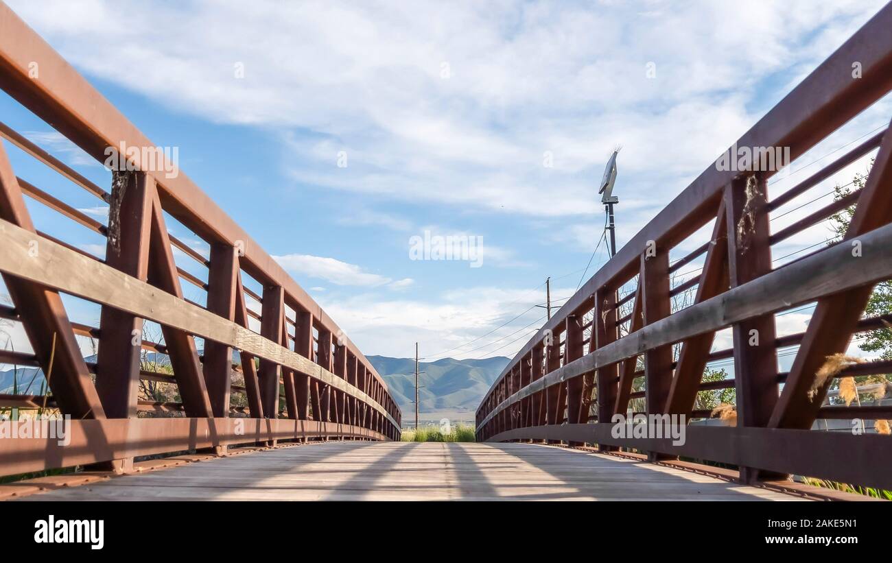 Panorama frame Focus on bridge with brown lattice metal railing and ...