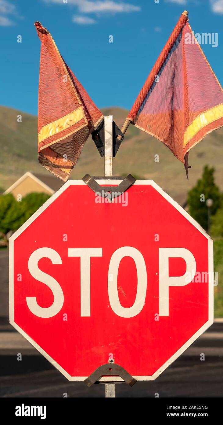 Vertical Selective focus of traffic Stop sign with two red flags ...