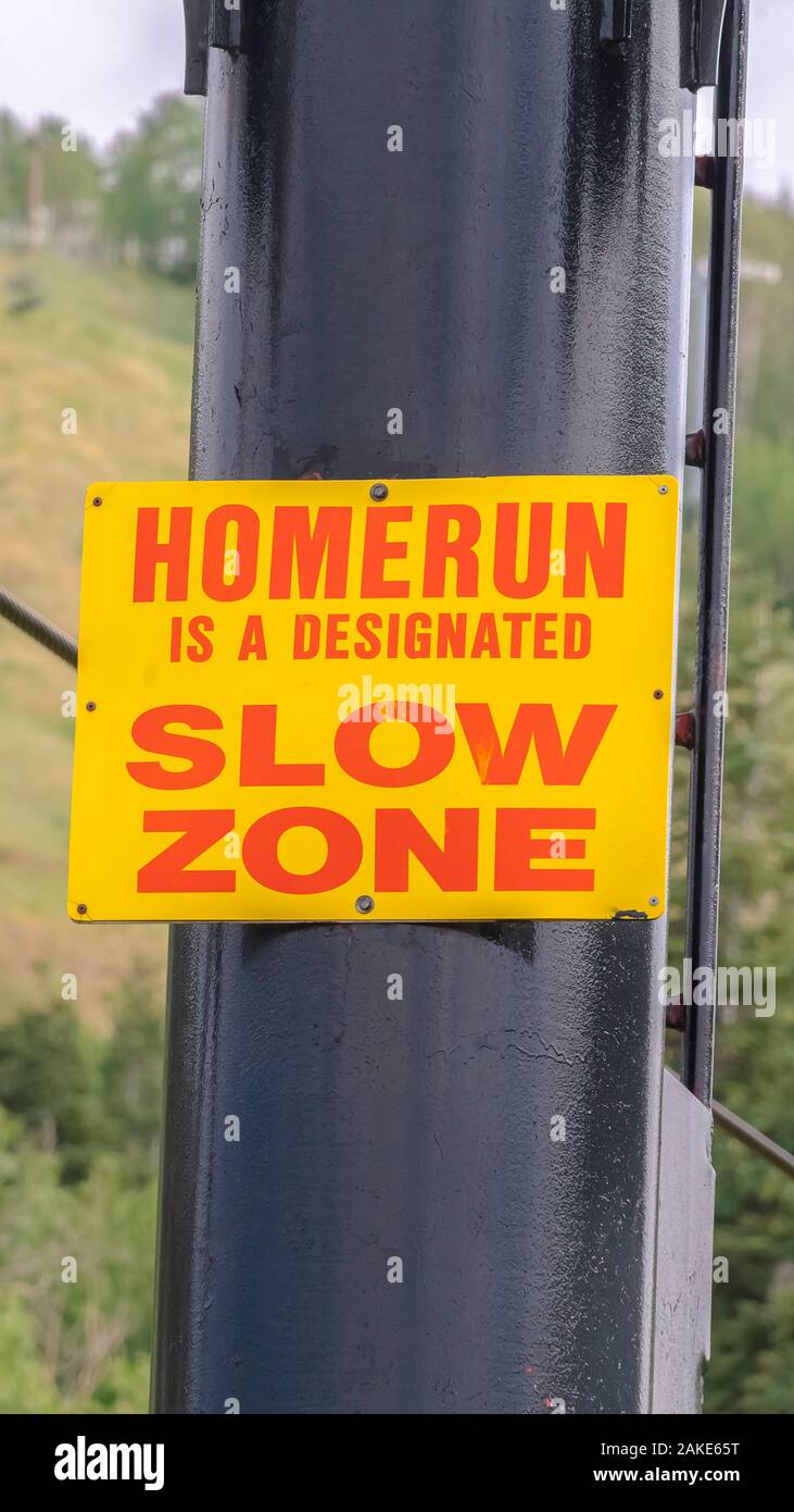 Vertical Safety sign on a chairlift against trails and mountain ...