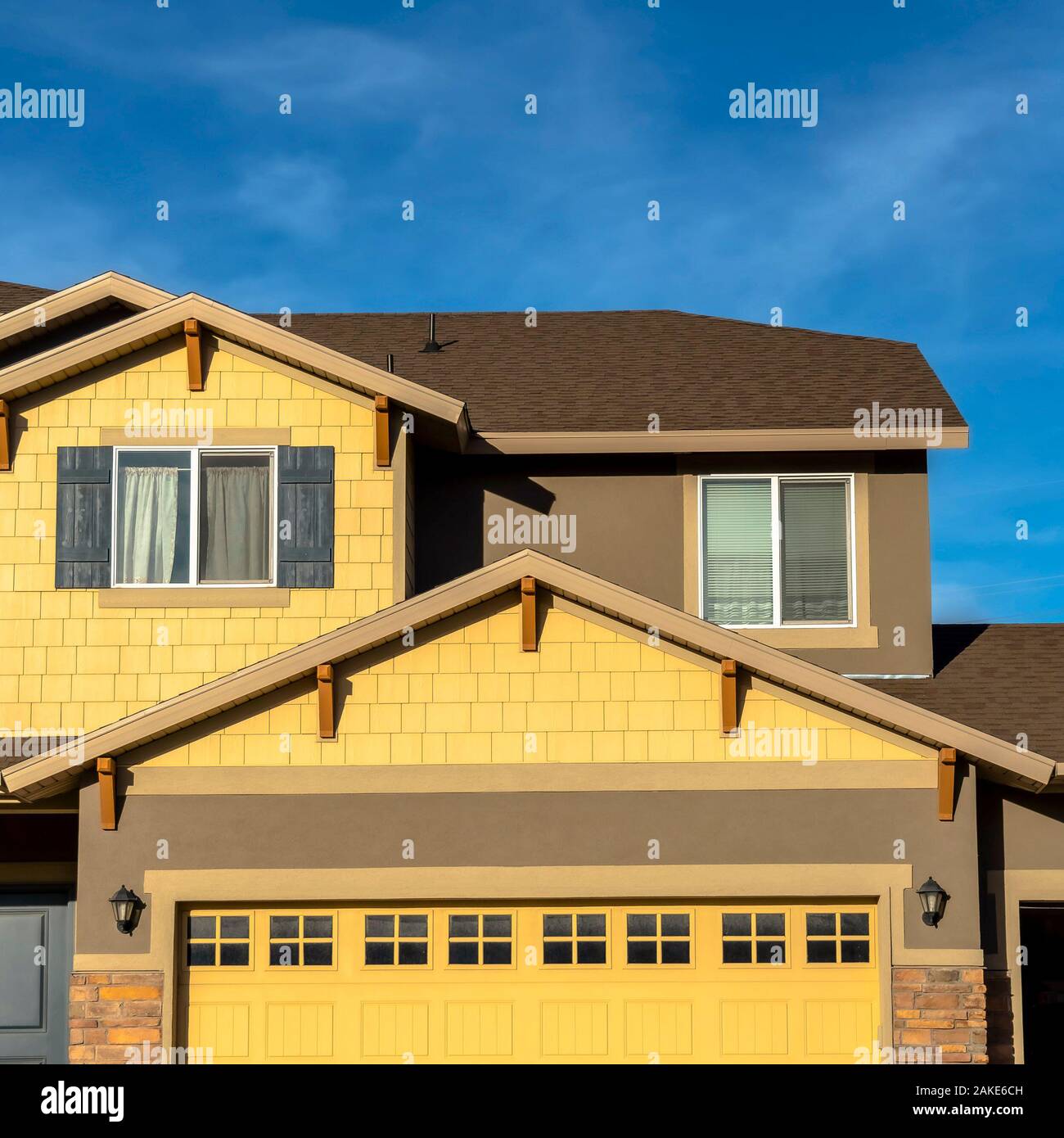 Square Exterior of home with view of driveway and garage against blue ...