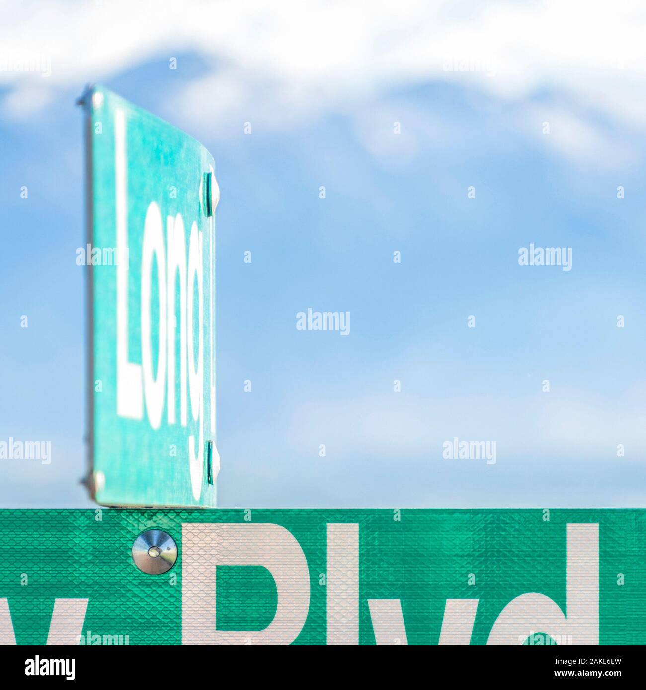 Square Selective focus on a green and white road street sign that reads ...