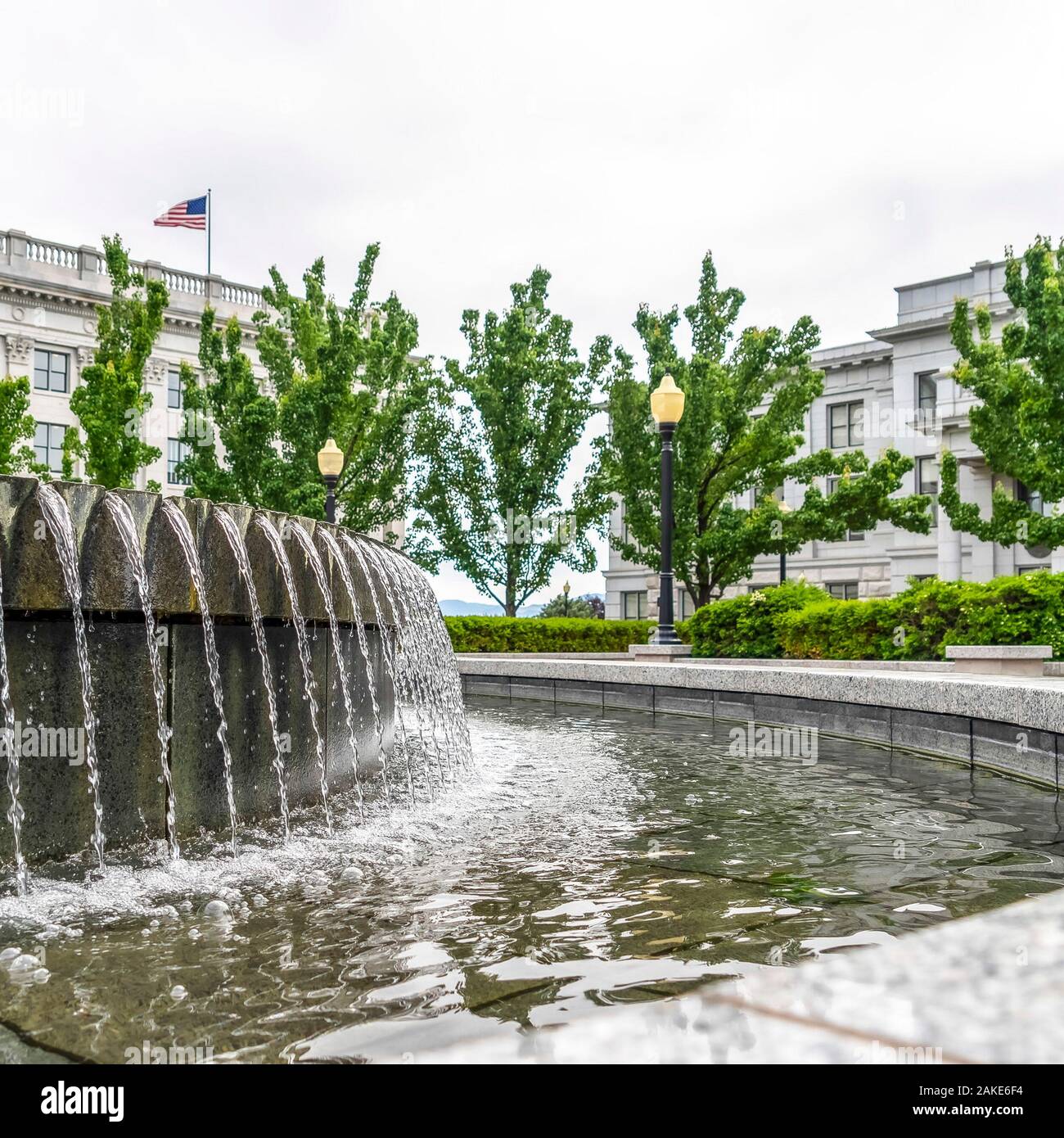 Square Circular water fountain with Utah State Capital Building in Salt ...