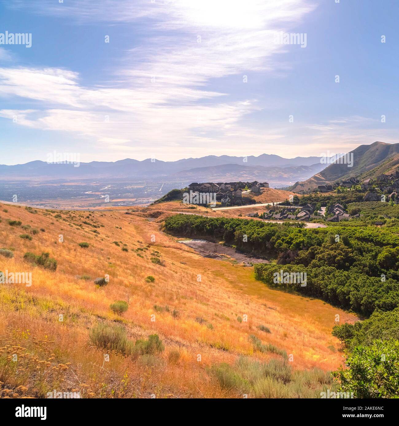 Square frame Scenic mountain landscape with houses amidst vast slopes ...