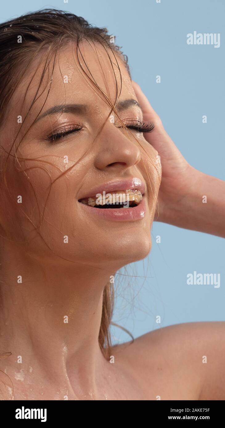 Wash your face and take care of your skin. Young woman washes her face ...