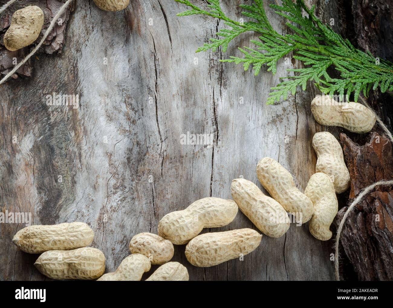 Raw peanuts scattered on aged wood. Background Stock Photo - Alamy