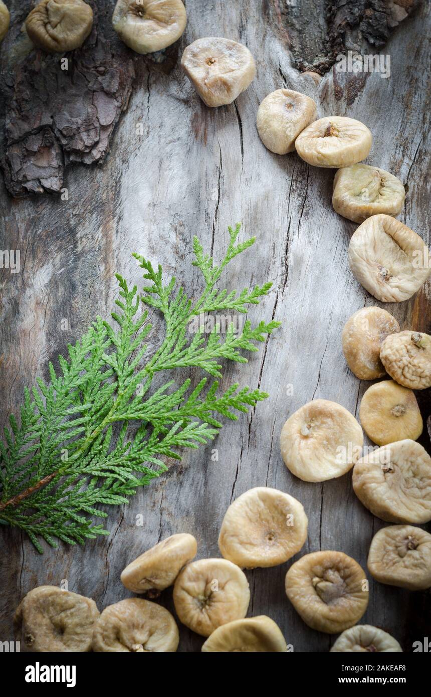 Composition of dried figs and the branches of fir on aged wood Stock ...