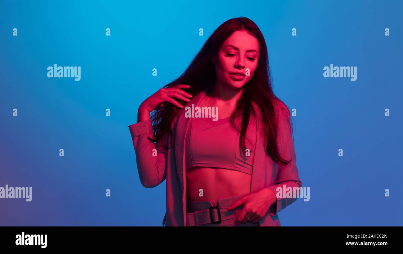Stylish young woman in blue. Fashion portrait with color light, shades ...