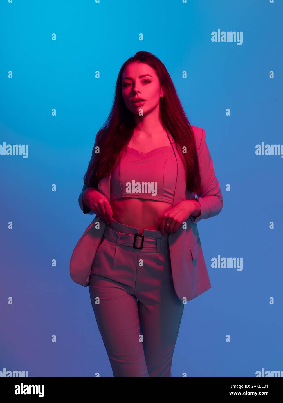 Fashion portrait with color light, shades of red and blue. Young ...