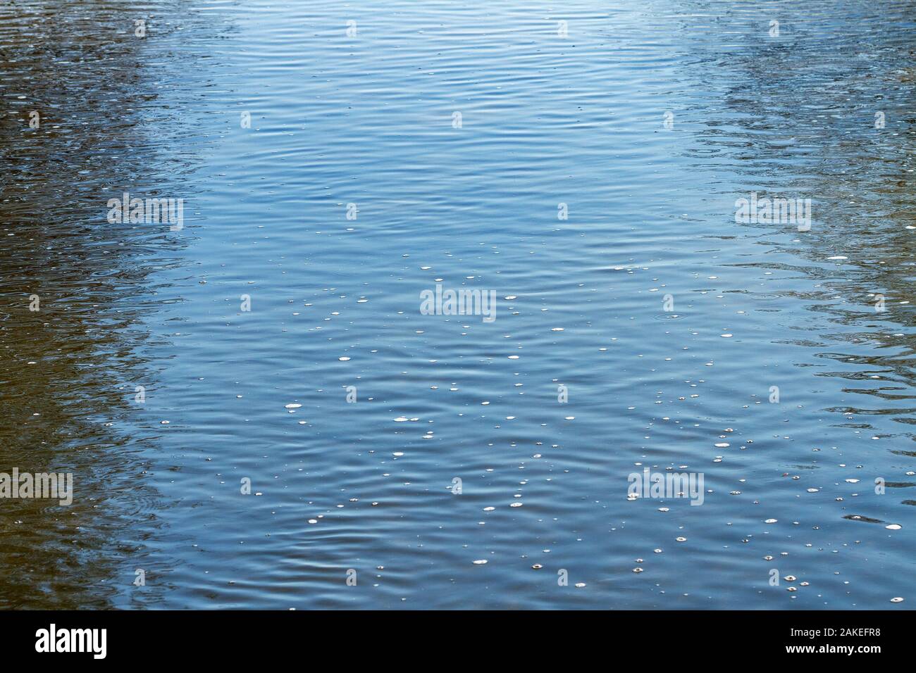 Surface of blue water with reflection Stock Photo - Alamy