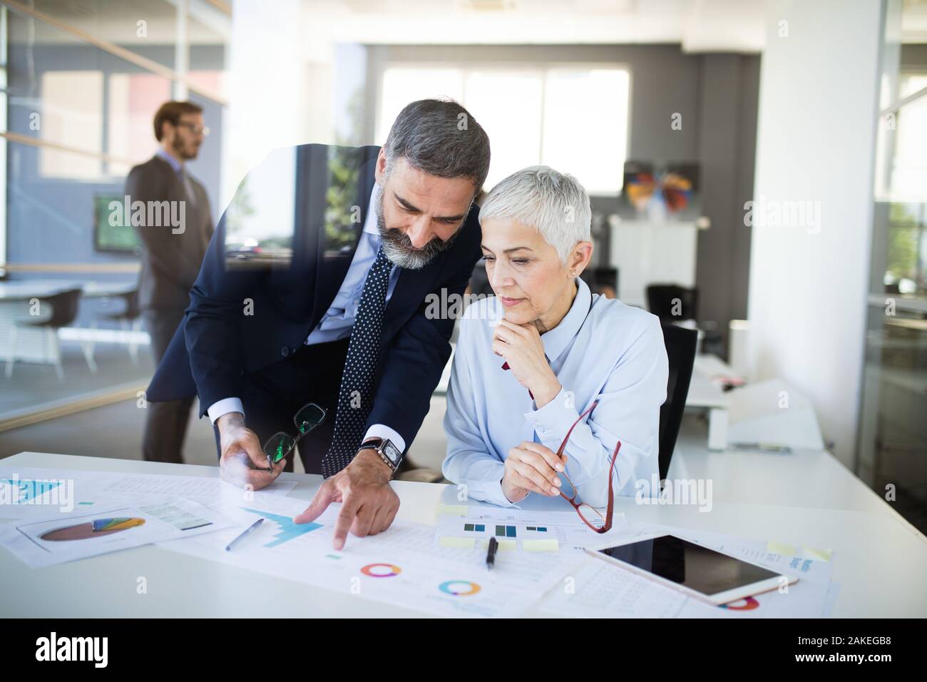 Portrait of happy business people discussing together in office Stock ...
