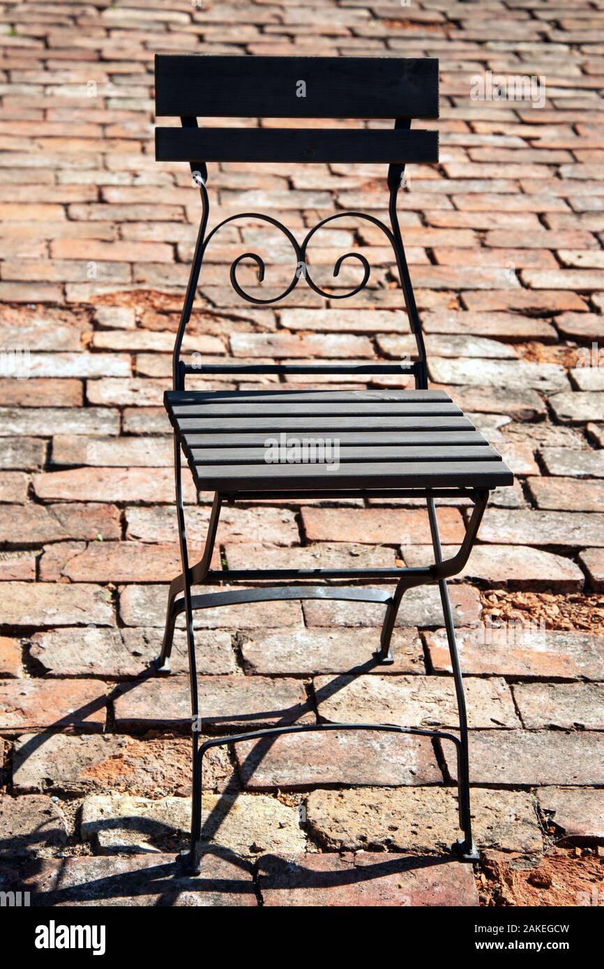 Lightweight chair on brick surface of floor Stock Photo - Alamy