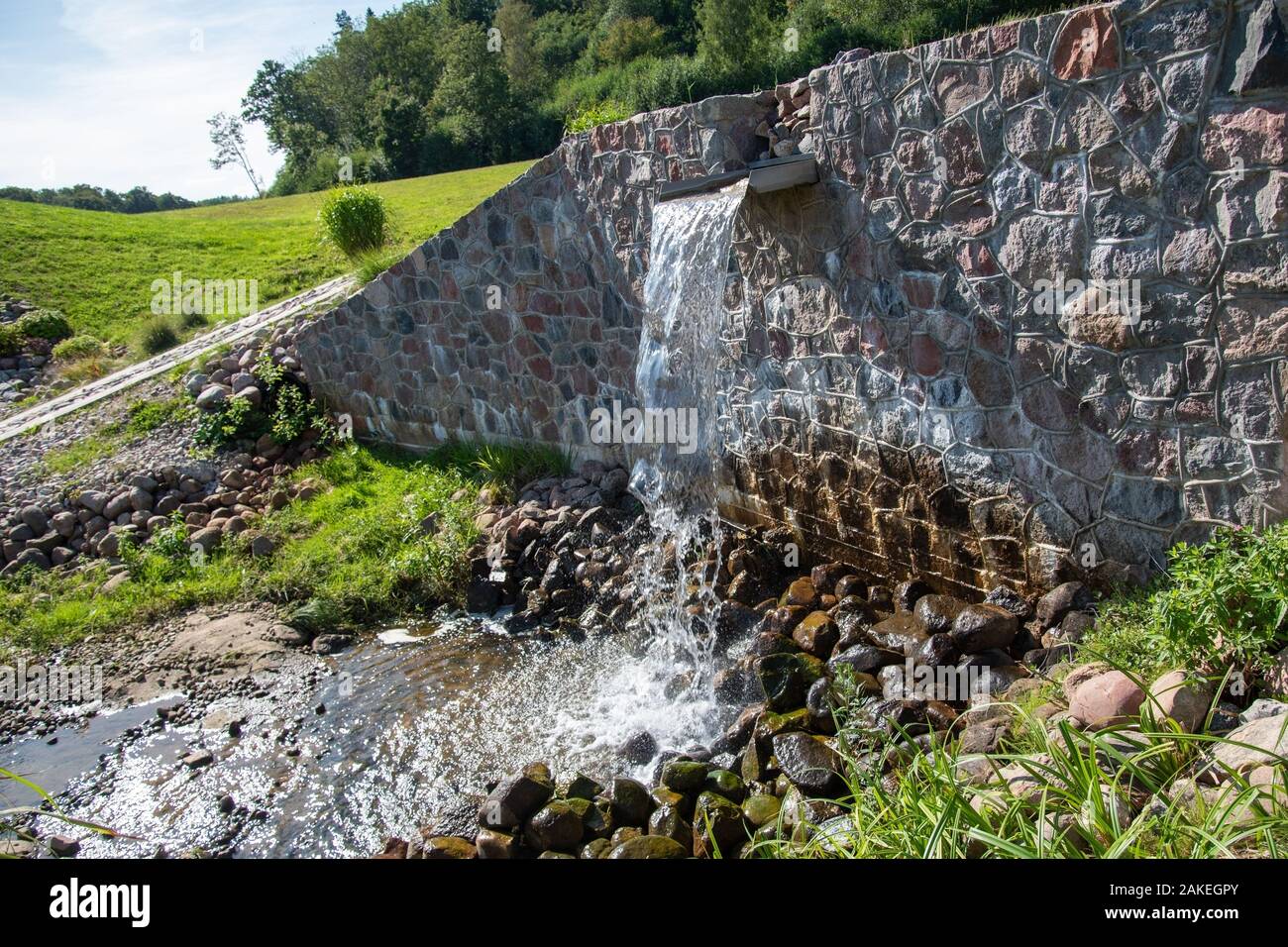 Waterfall of natural source in stone surface Stock Photo - Alamy