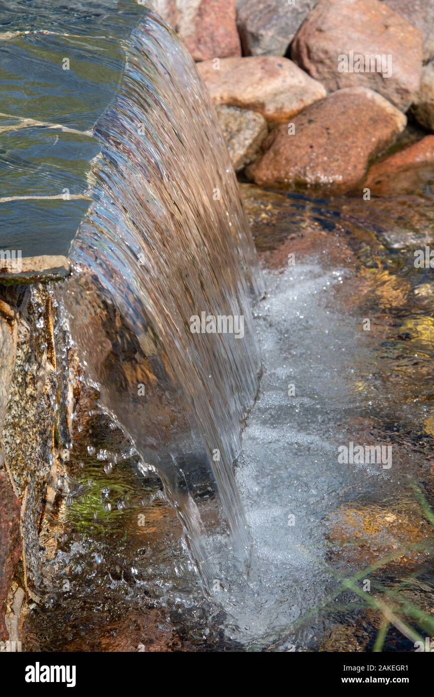 Waterfall of natural source in stone surface Stock Photo - Alamy