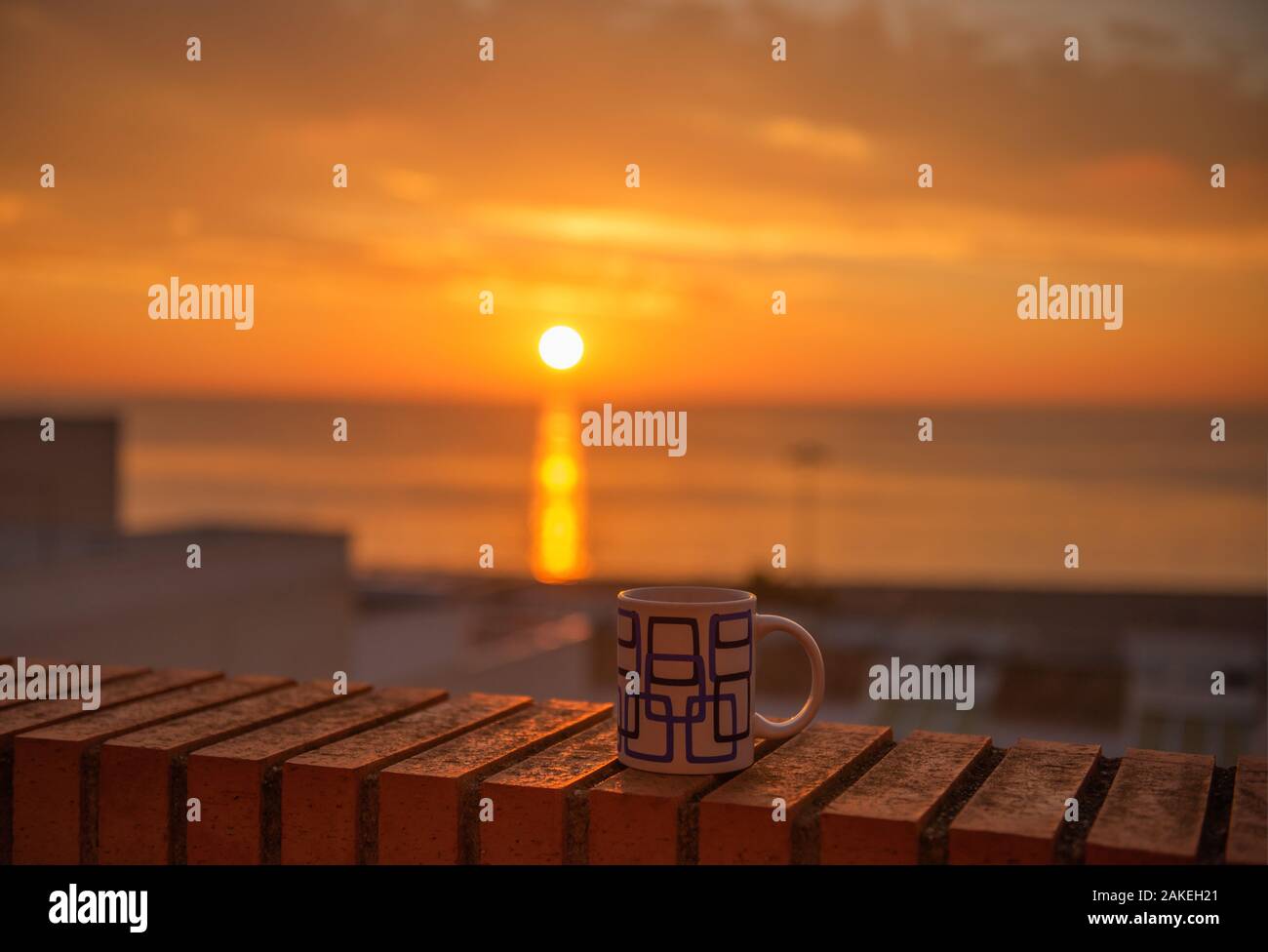 Tea cup with tea leaves in sunset Stock Photo - Alamy