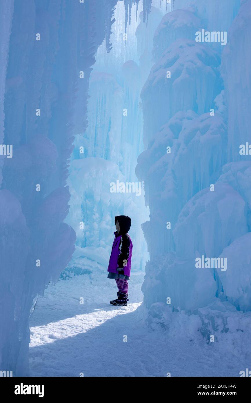 Young girl standing in an ice cave with dramatic ray of light Stock ...