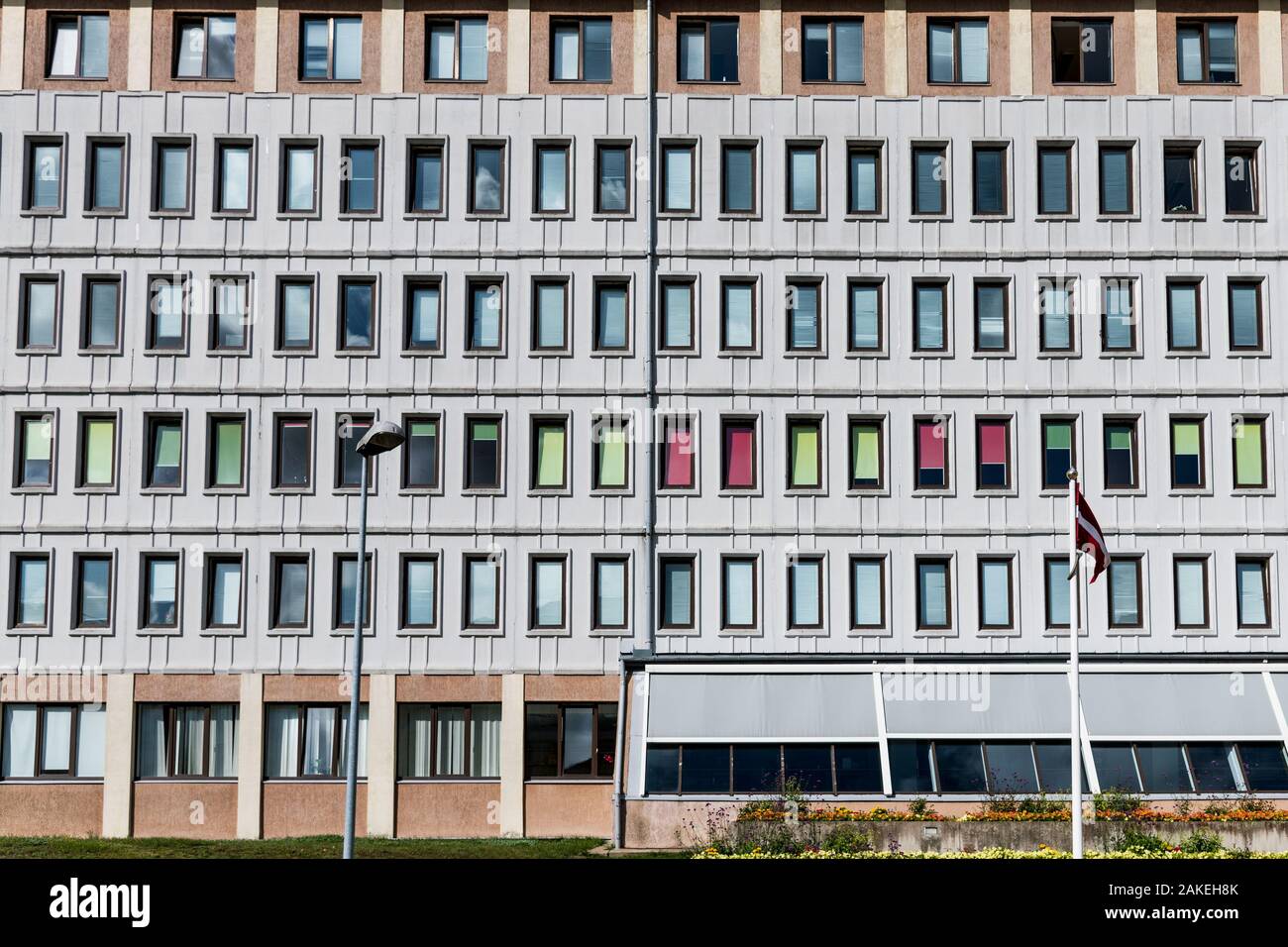 Many multi colored windows on big building Stock Photo - Alamy
