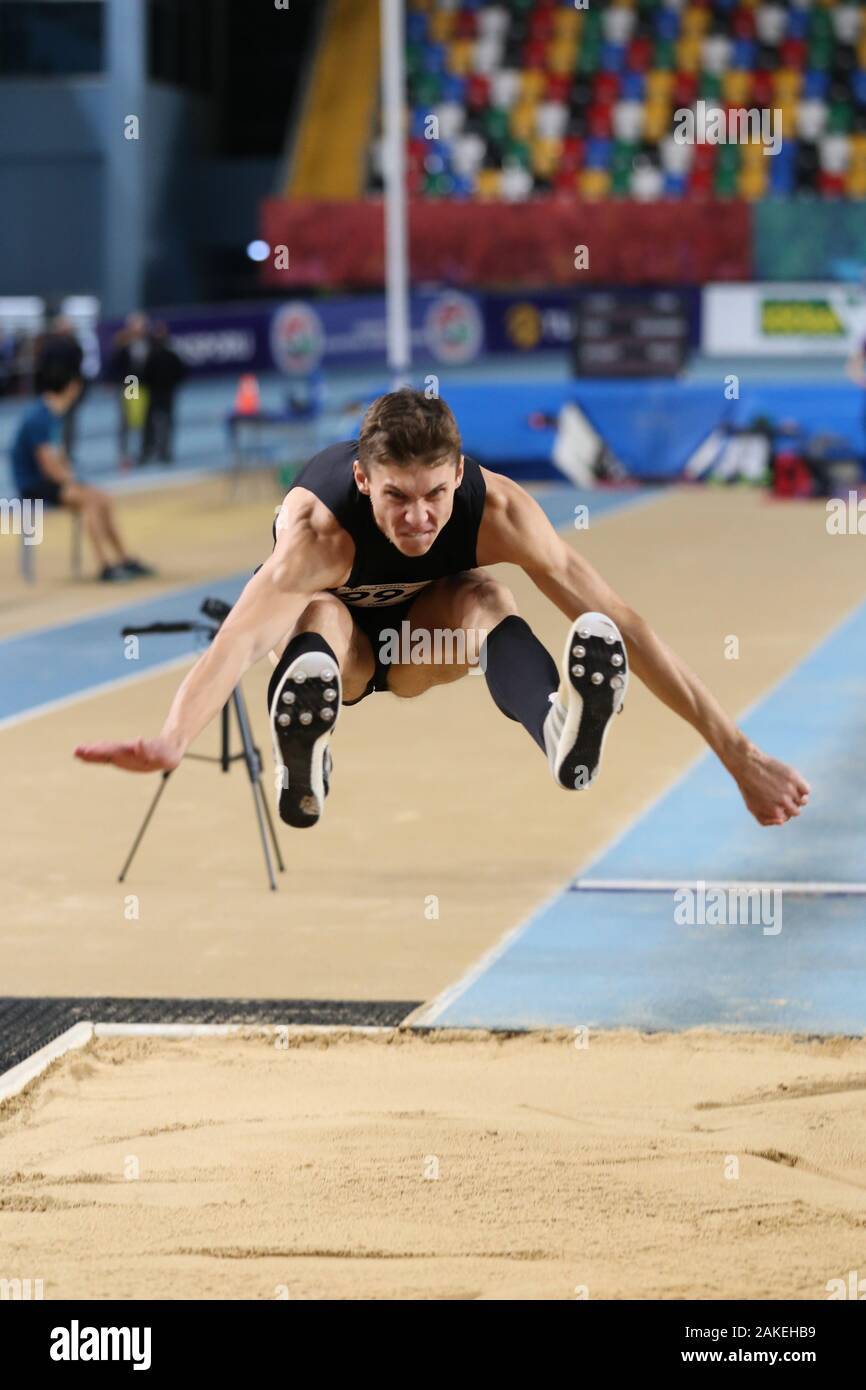 ISTANBUL, TURKEY - DECEMBER 28, 2019: Undefined athlete long jumping ...