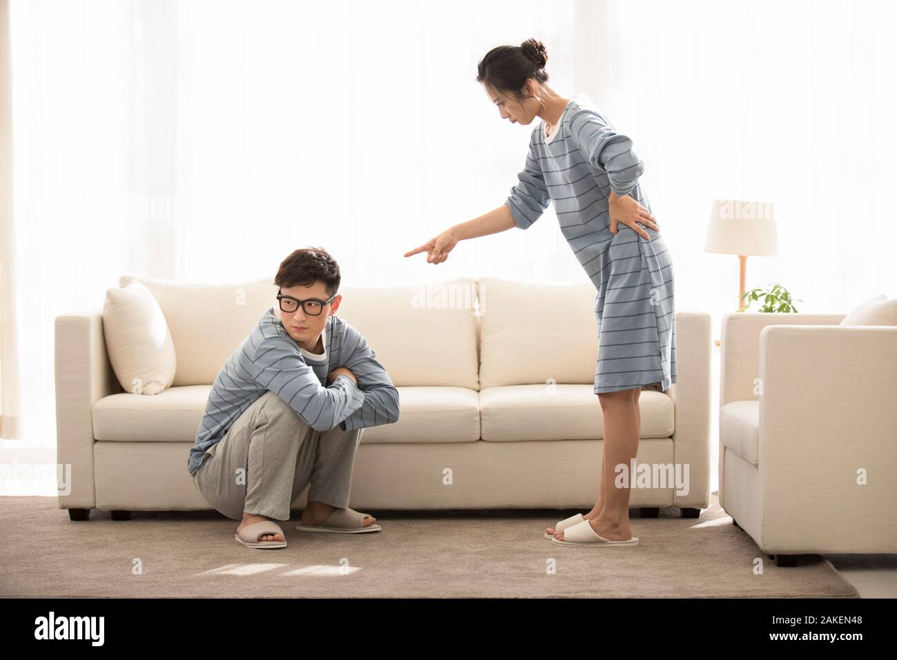Young Chinese couple arguing in living room Stock Photo - Alamy