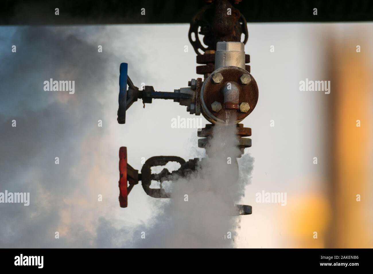 broken valve at the factory hydraulic system, leaking hot liquid and ...