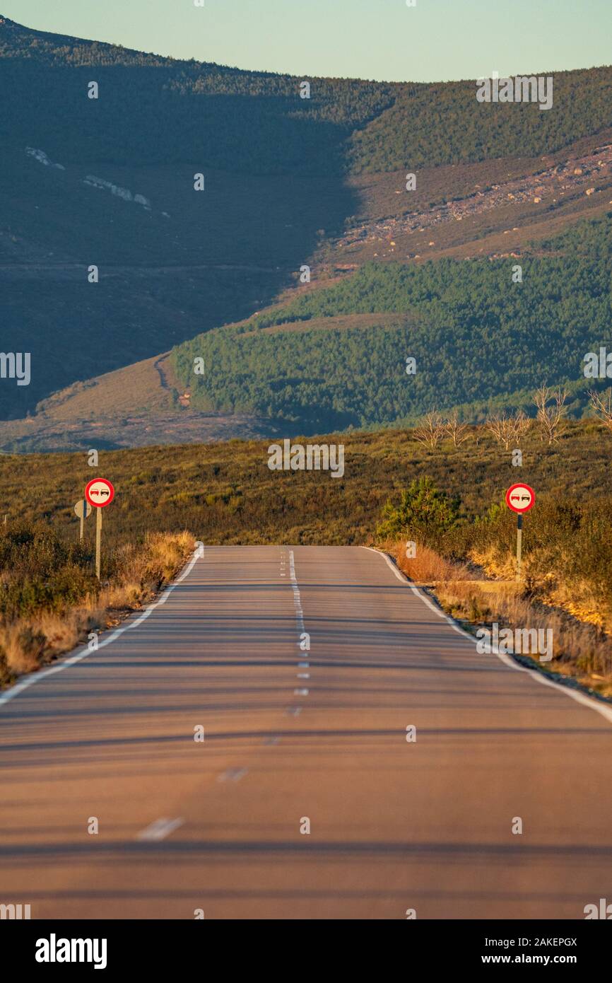 Road to the mountain with no overtaking signs Stock Photo - Alamy