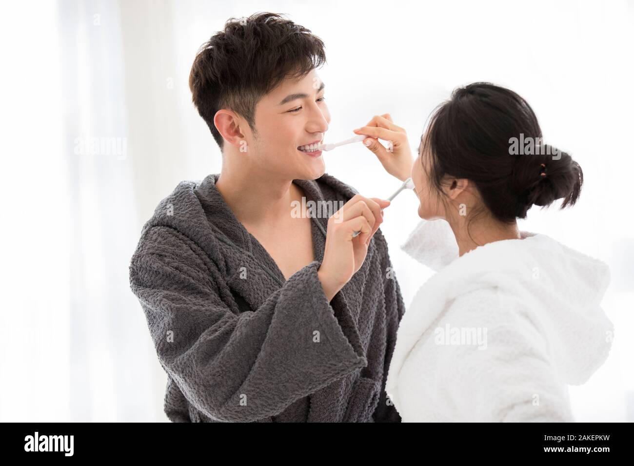 Young Chinese couple brushing teeth at home Stock Photo - Alamy