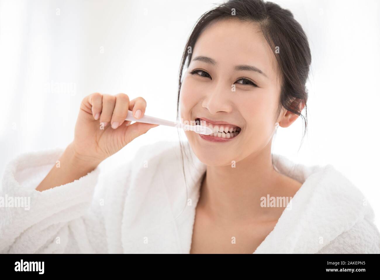 Young Chinese woman brushing teeth Stock Photo - Alamy