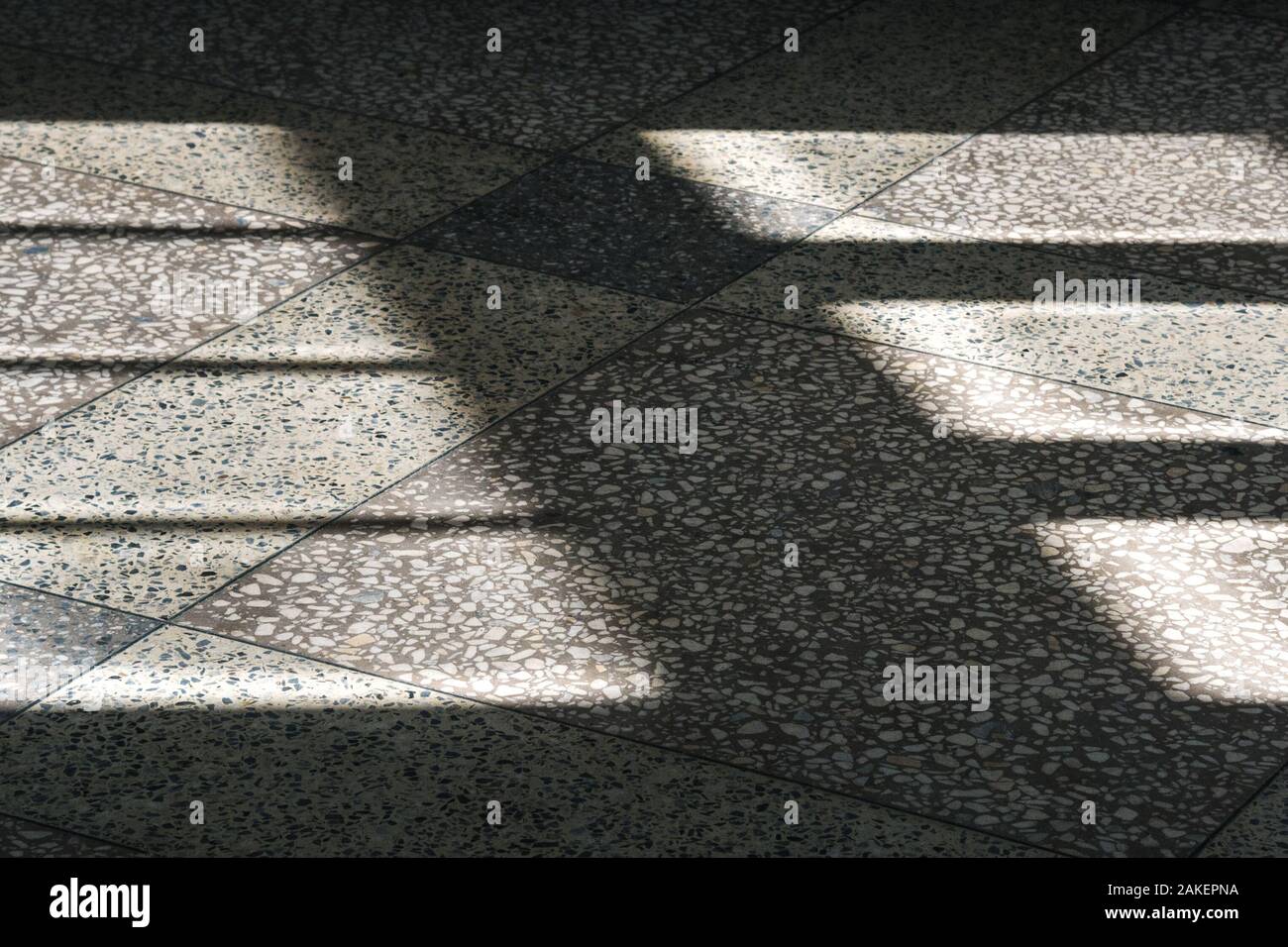 Shadow of window on dark tiles floor Stock Photo - Alamy